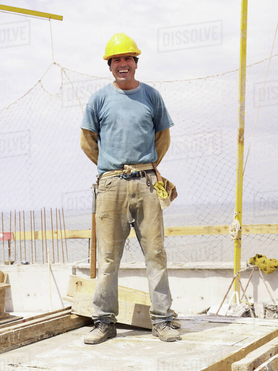 Hispanic worker smiling on construction site - Royalty-free Stock Photo ...