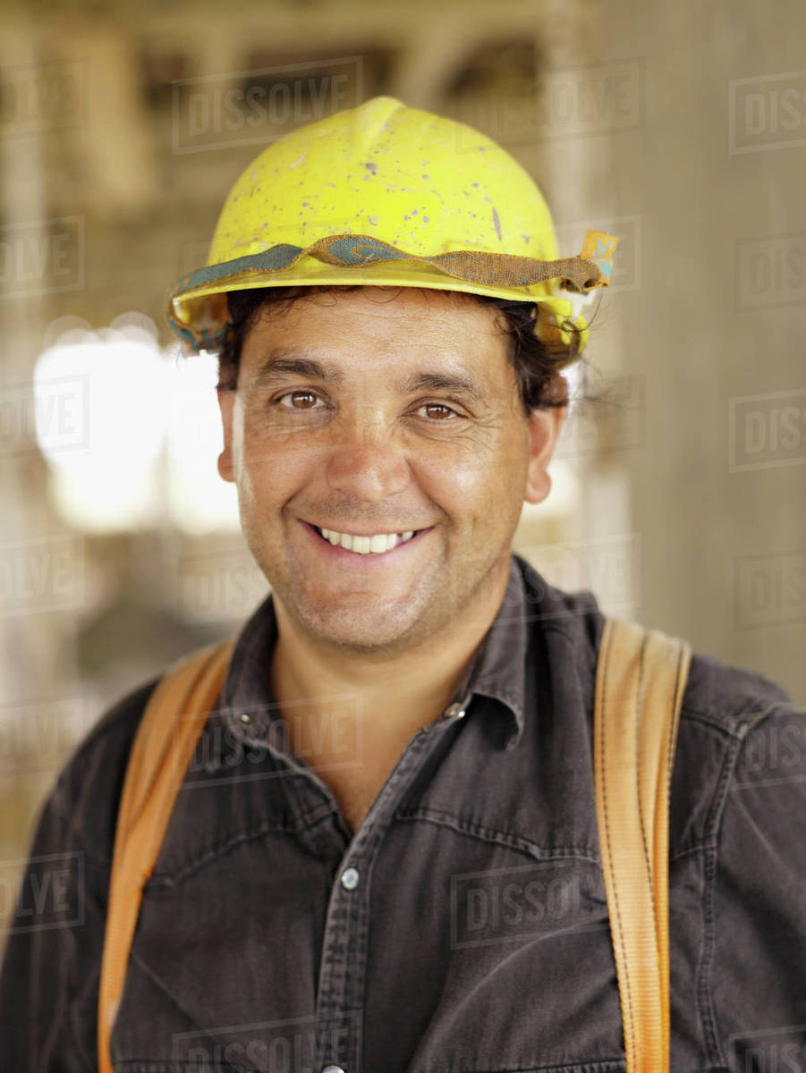 Hispanic worker smiling on construction site - Royalty-free Stock Photo ...