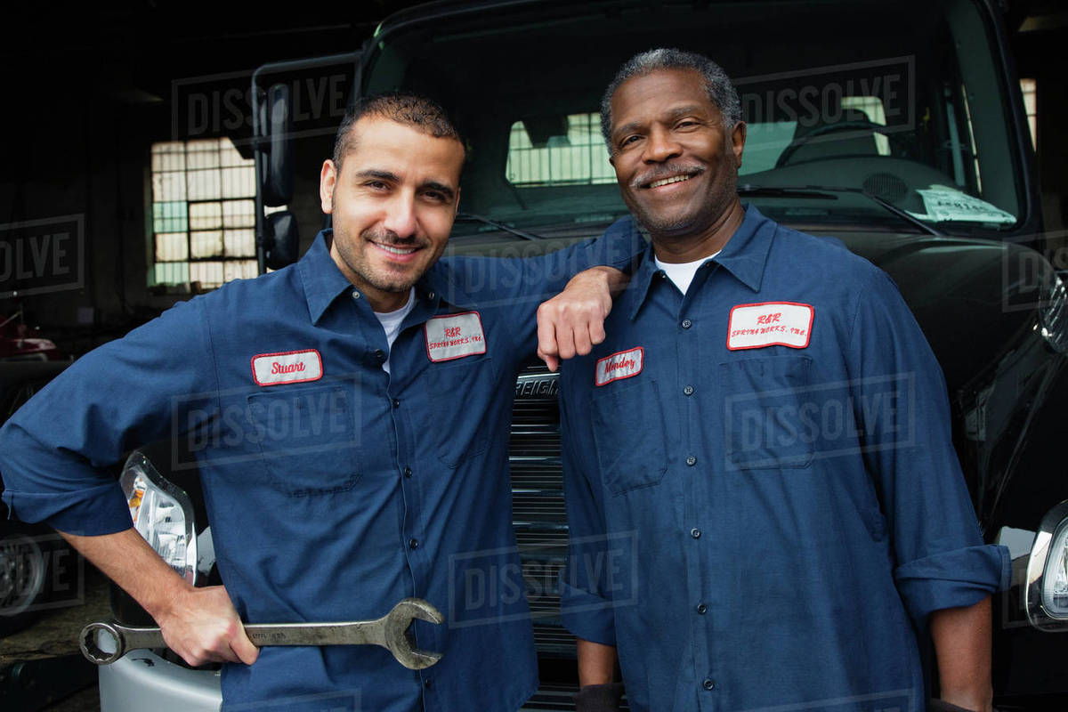 Mechanics standing in repair shop - Royalty-free Stock Photo | Dissolve