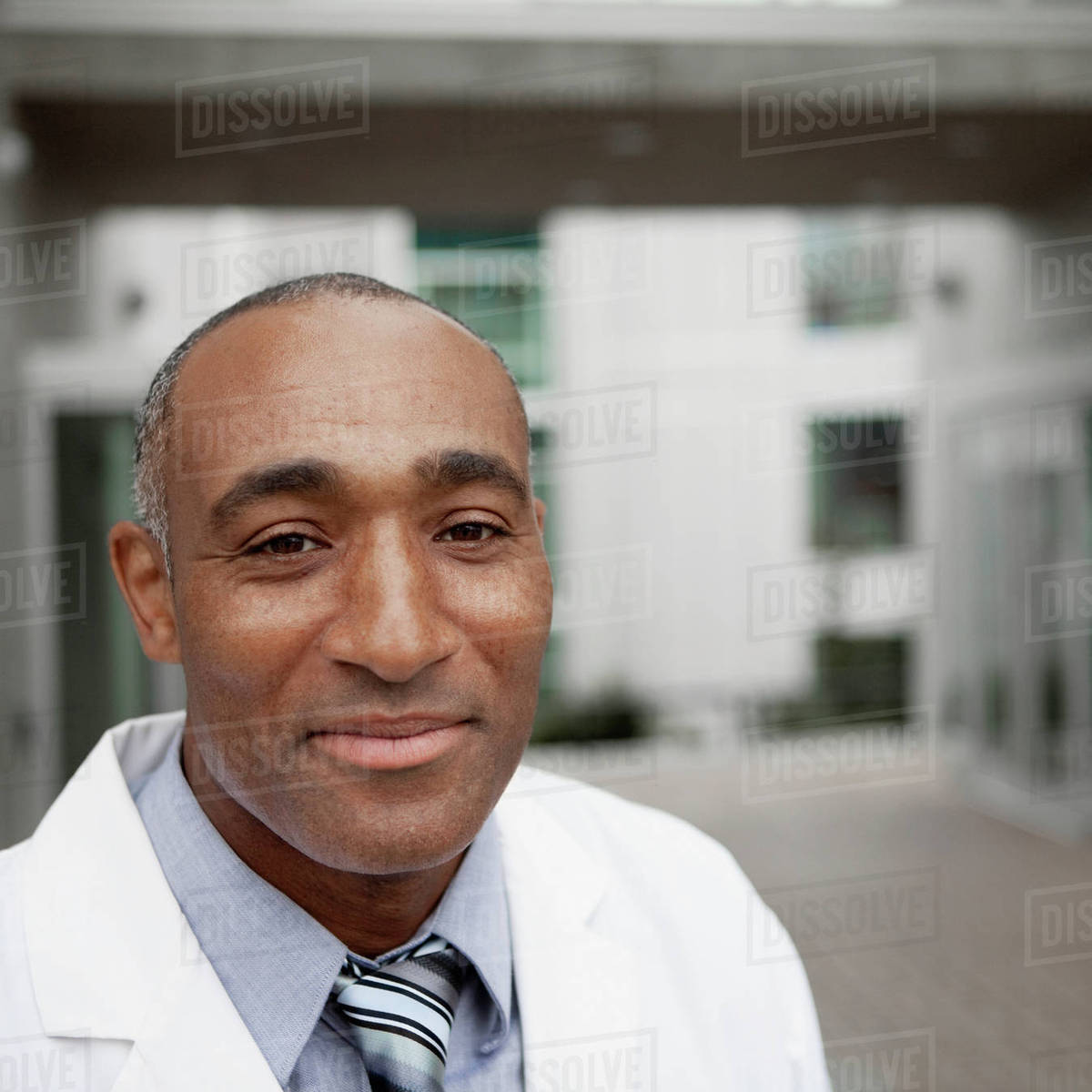 Mixed race doctor standing outdoors - Stock Photo - Dissolve