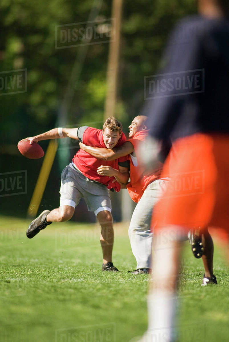 Men playing football - Royalty-free Stock Photo | Dissolve