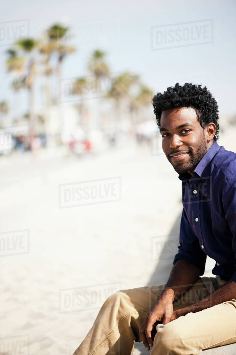 African American man sitting outdoors - Royalty-free Stock Photo | Dissolve