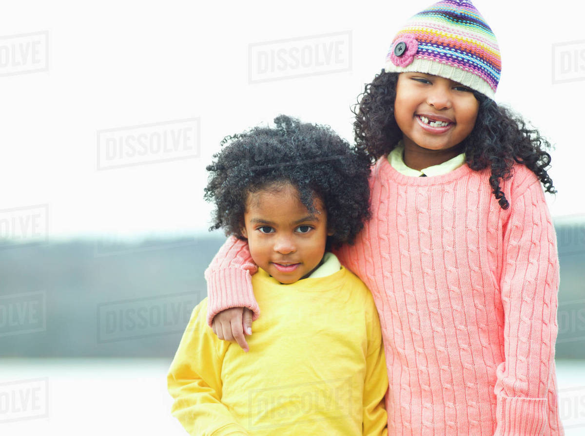 Mixed race children posing outdoors - Royalty-free Stock Photo | Dissolve