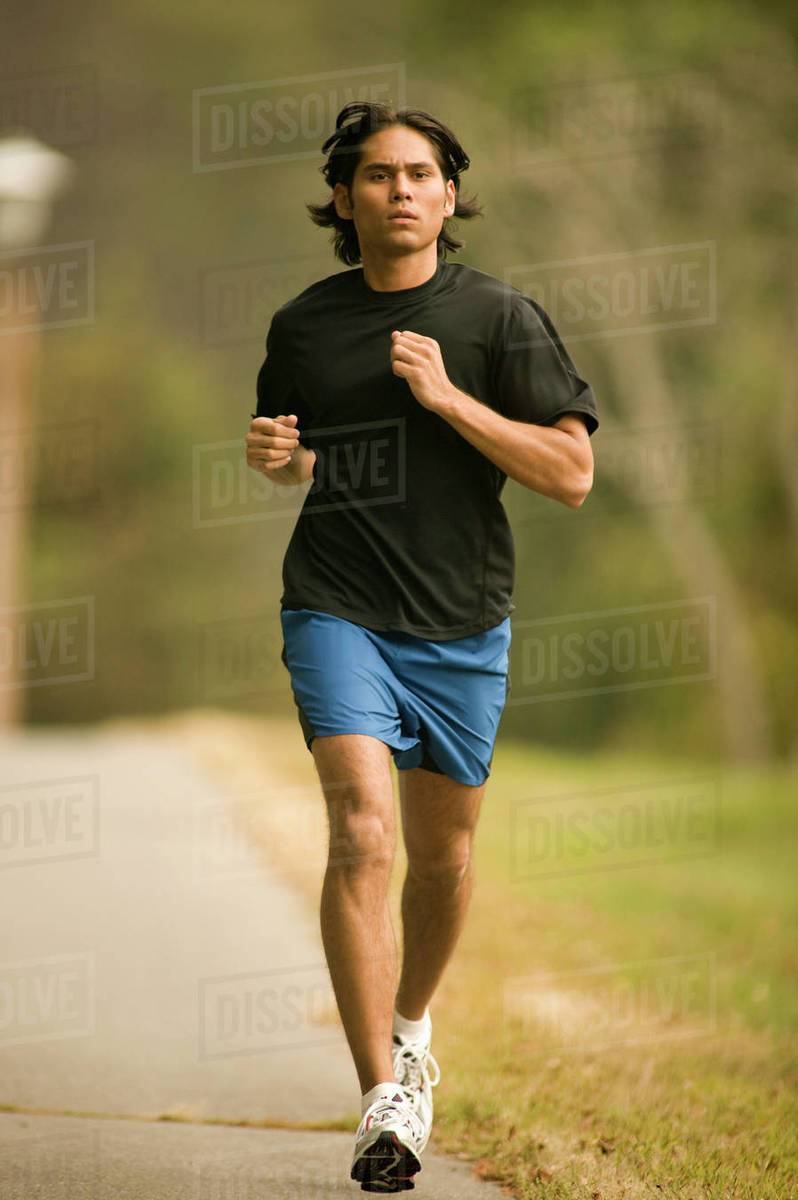 Man jogging on sidewalk - Royalty-free Stock Photo | Dissolve