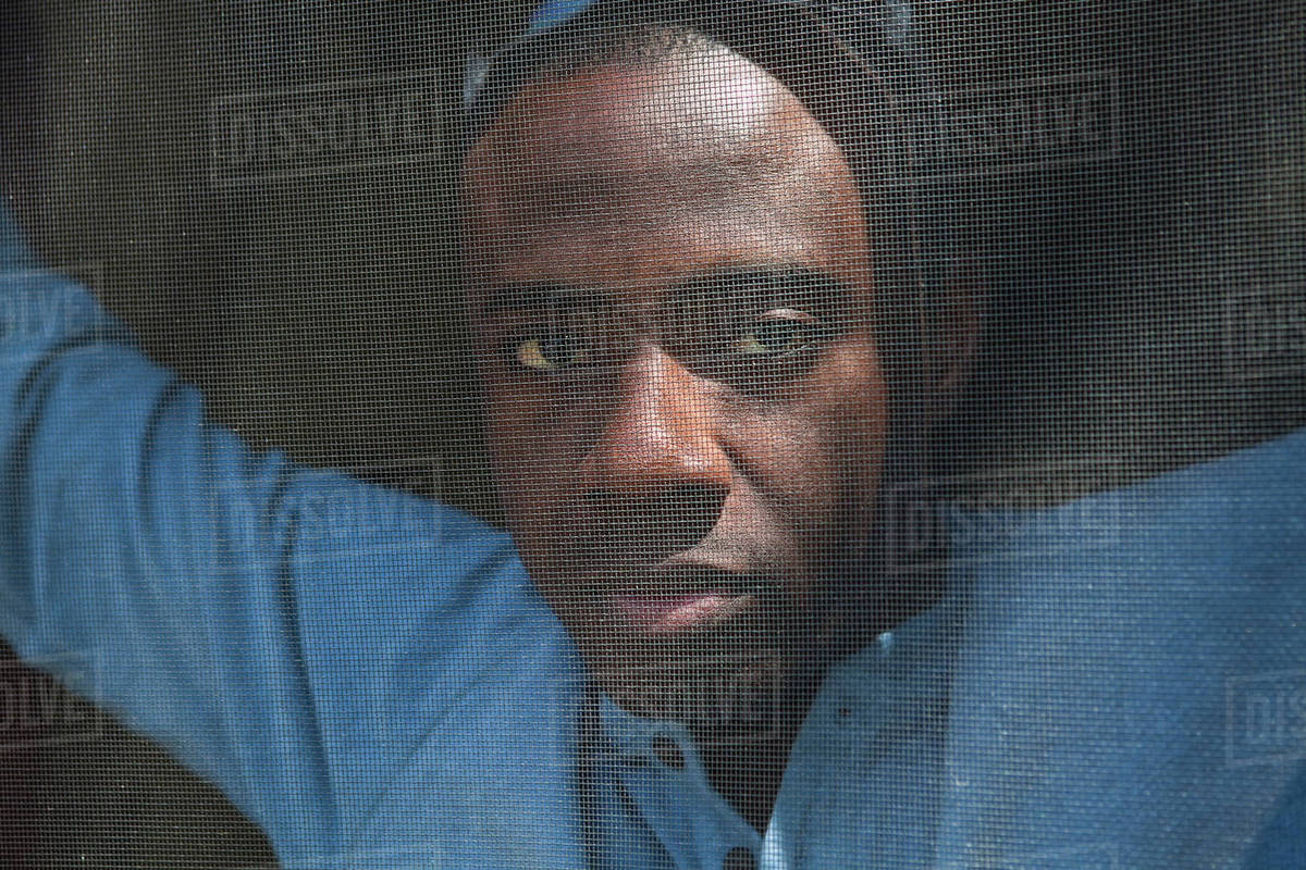 Black man behind screen - Stock Photo - Dissolve