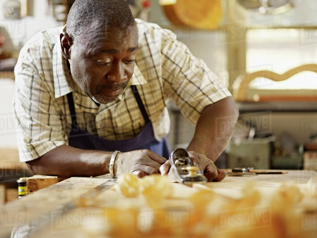Black craftsman working in workshop - Stock Photo - Dissolve