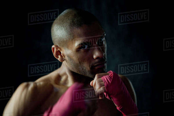 Hispanic boxer warming up - Stock Photo - Dissolve