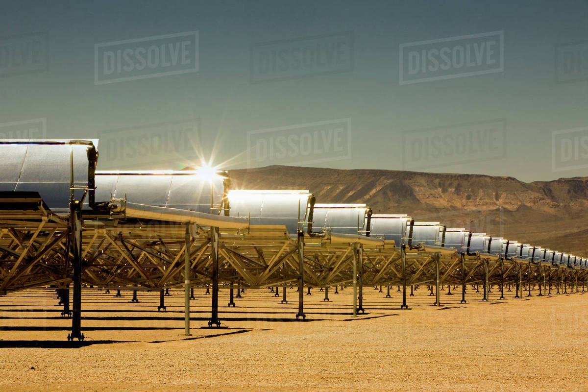 Rows of solar panels in desert - Stock Photo - Dissolve