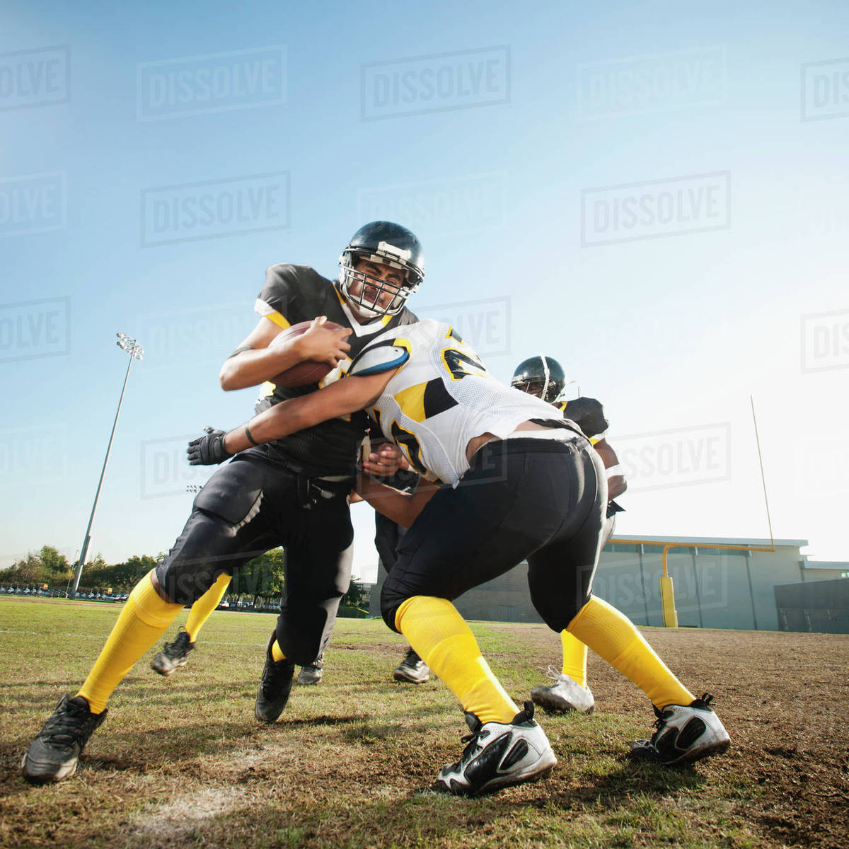 Football player tackling player on football field - Royalty-free Stock ...