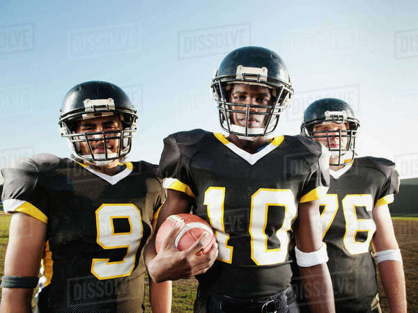Football players standing on football field - Royalty-free Stock Photo ...