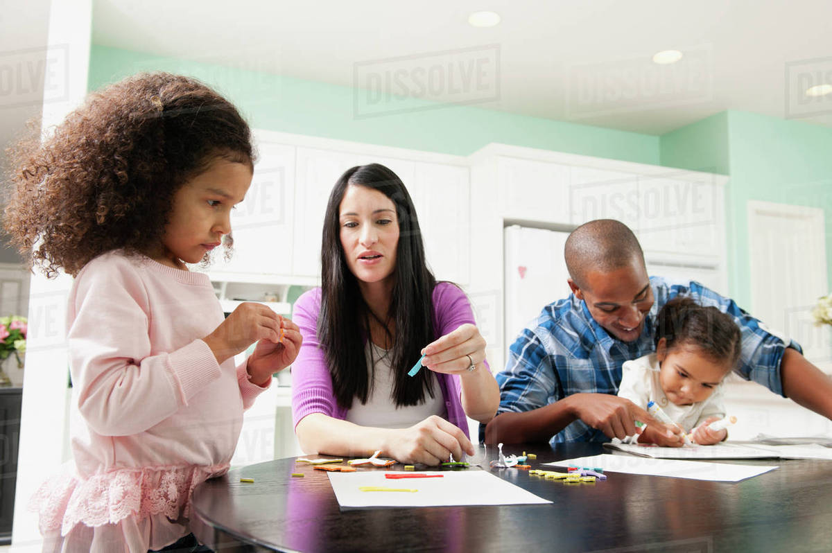 Family doing arts and crafts together - Stock Photo - Dissolve