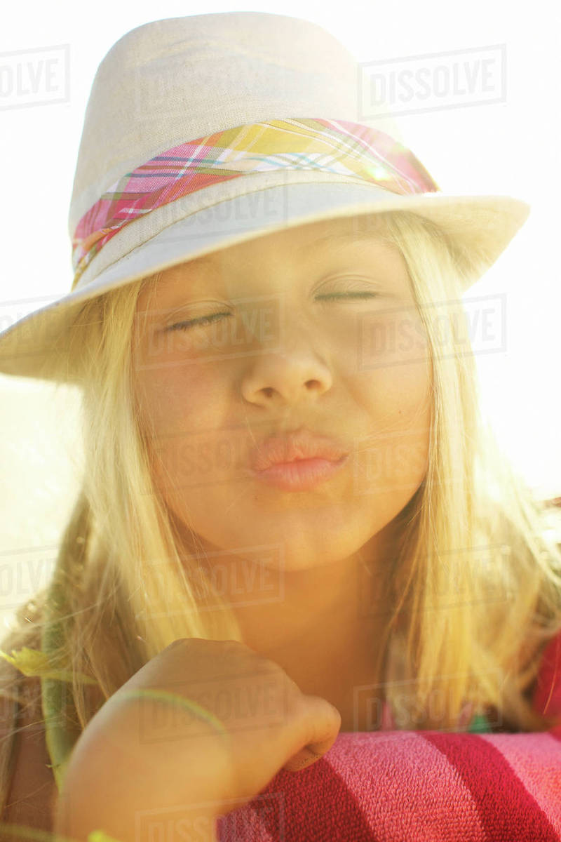 Mixed race girl making kissing motion - Stock Photo - Dissolve