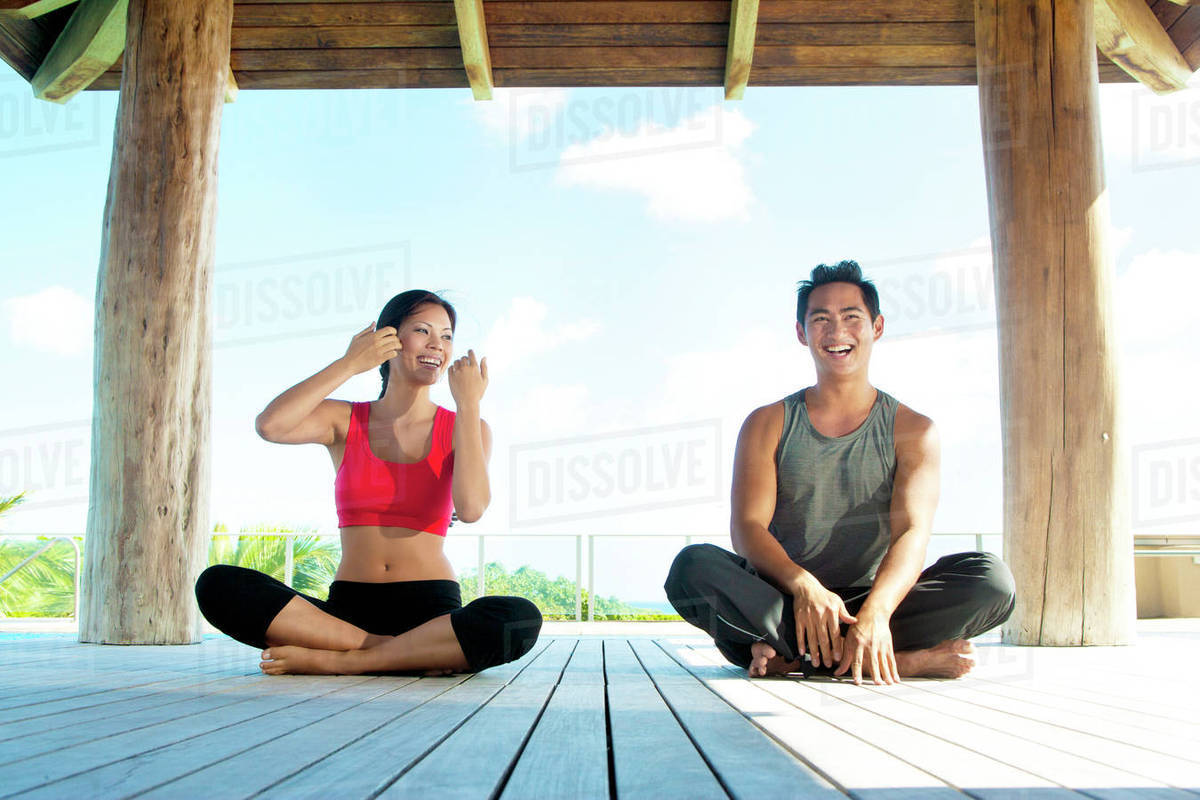 Couple practicing yoga together - Royalty-free Stock Photo | Dissolve