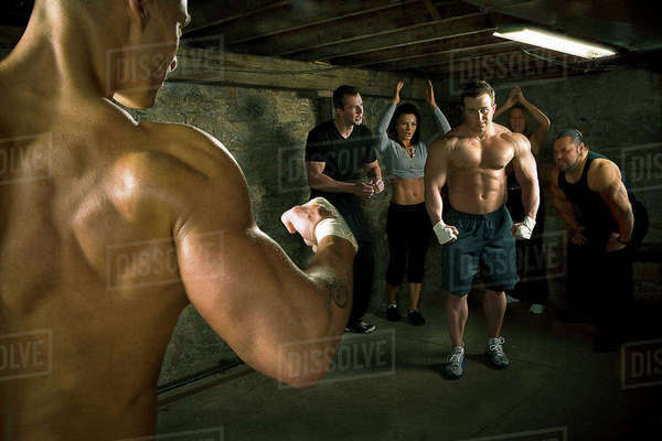 People watching two men boxing without gloves - Stock Photo - Dissolve