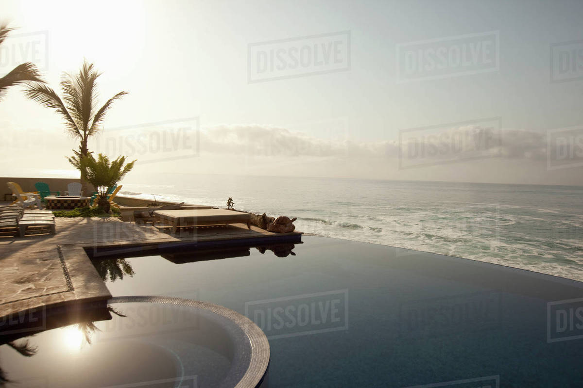 Infinity pool near ocean - Stock Photo - Dissolve