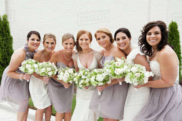 Smiling bridal party standing with bride - Royalty-free Stock Photo ...