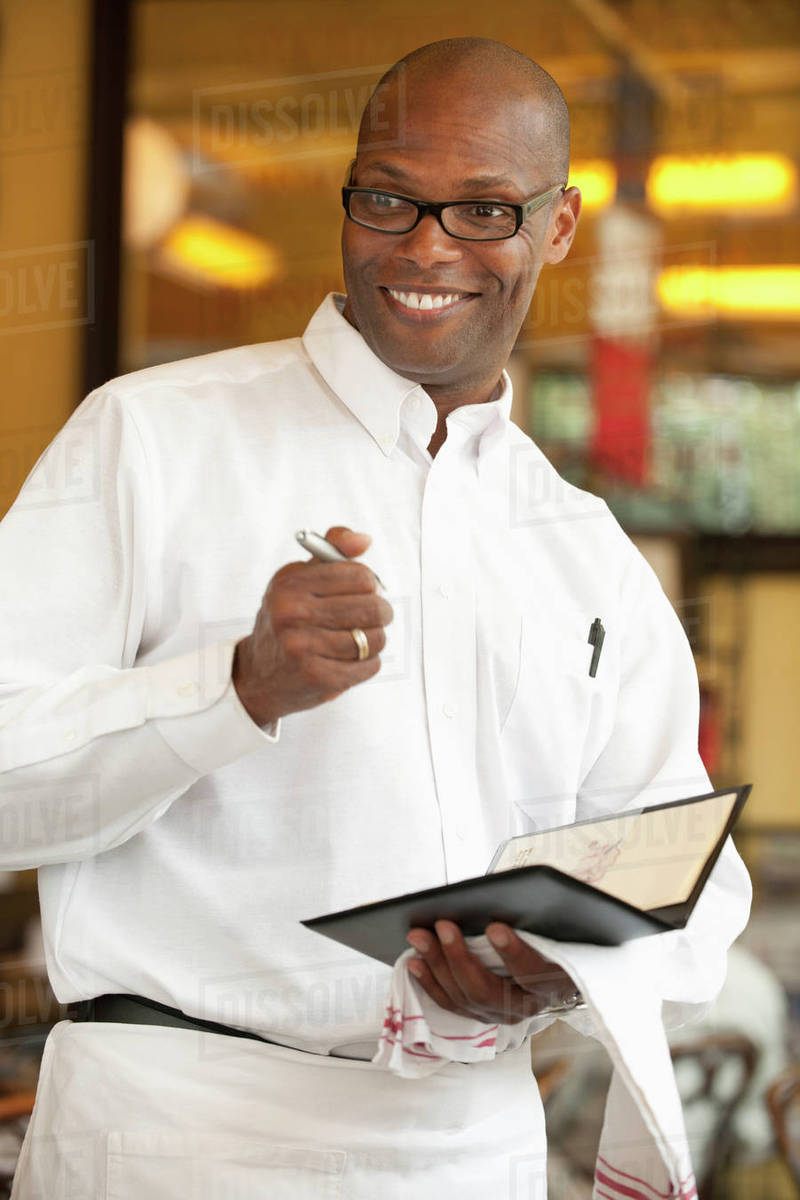 African American waiter holding order pad in restaurant - Stock Photo ...