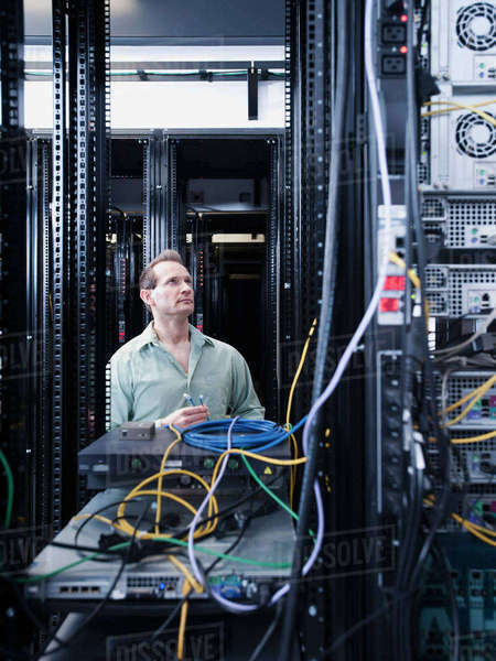 Caucasian businessman working in server room - Royalty-free Stock Photo ...