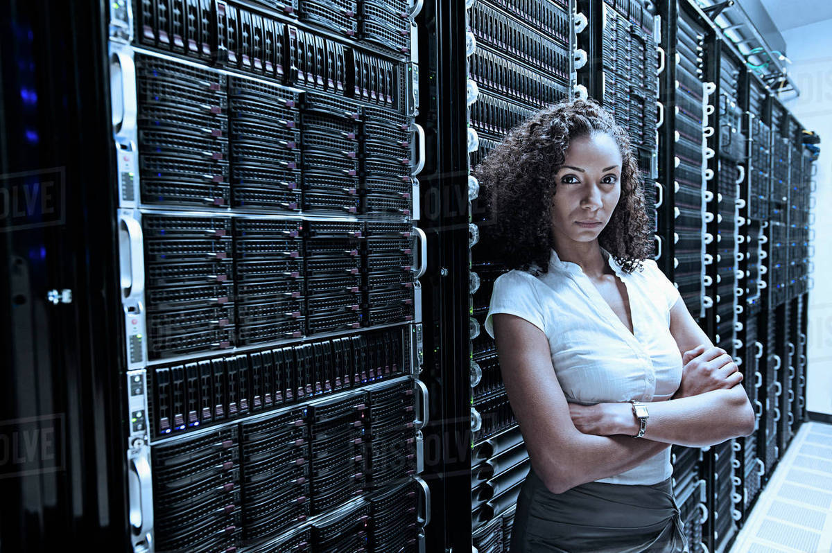 Black businesswoman standing in server room - Royalty-free Stock Photo ...