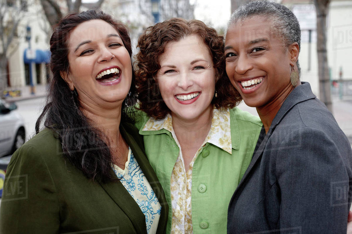 Smiling friends standing together - Royalty-free Stock Photo | Dissolve