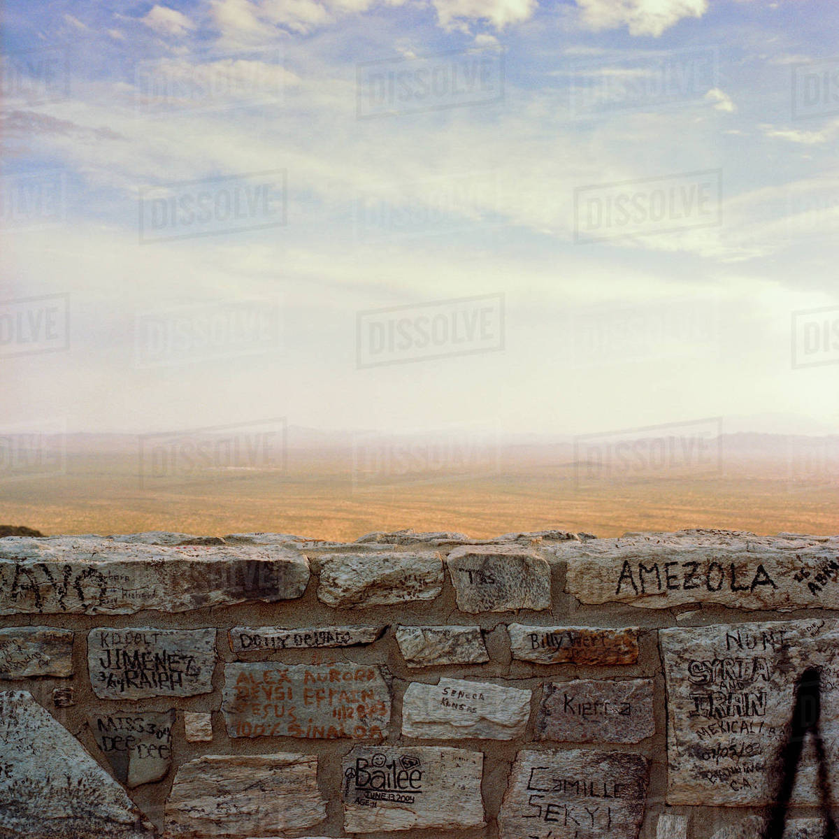 Graffiti on wall with desert in background - Stock Photo - Dissolve