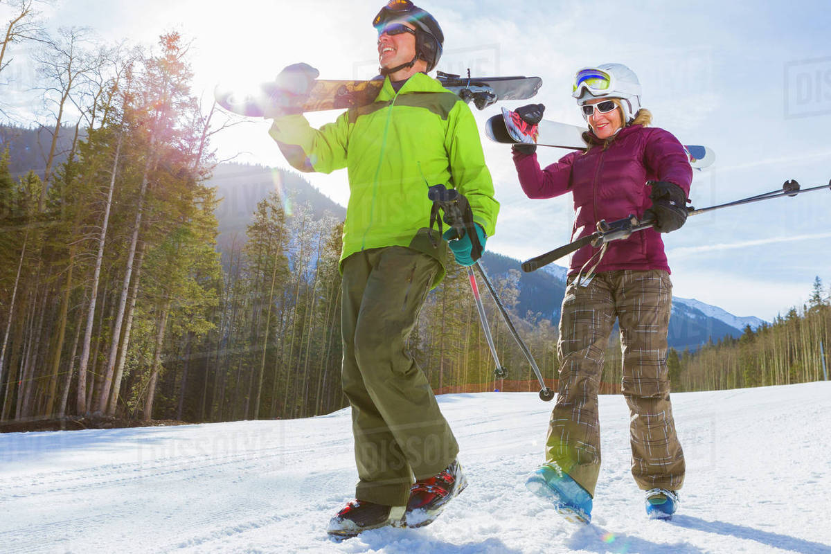 Caucasian couple skiing together - Royalty-free Stock Photo | Dissolve