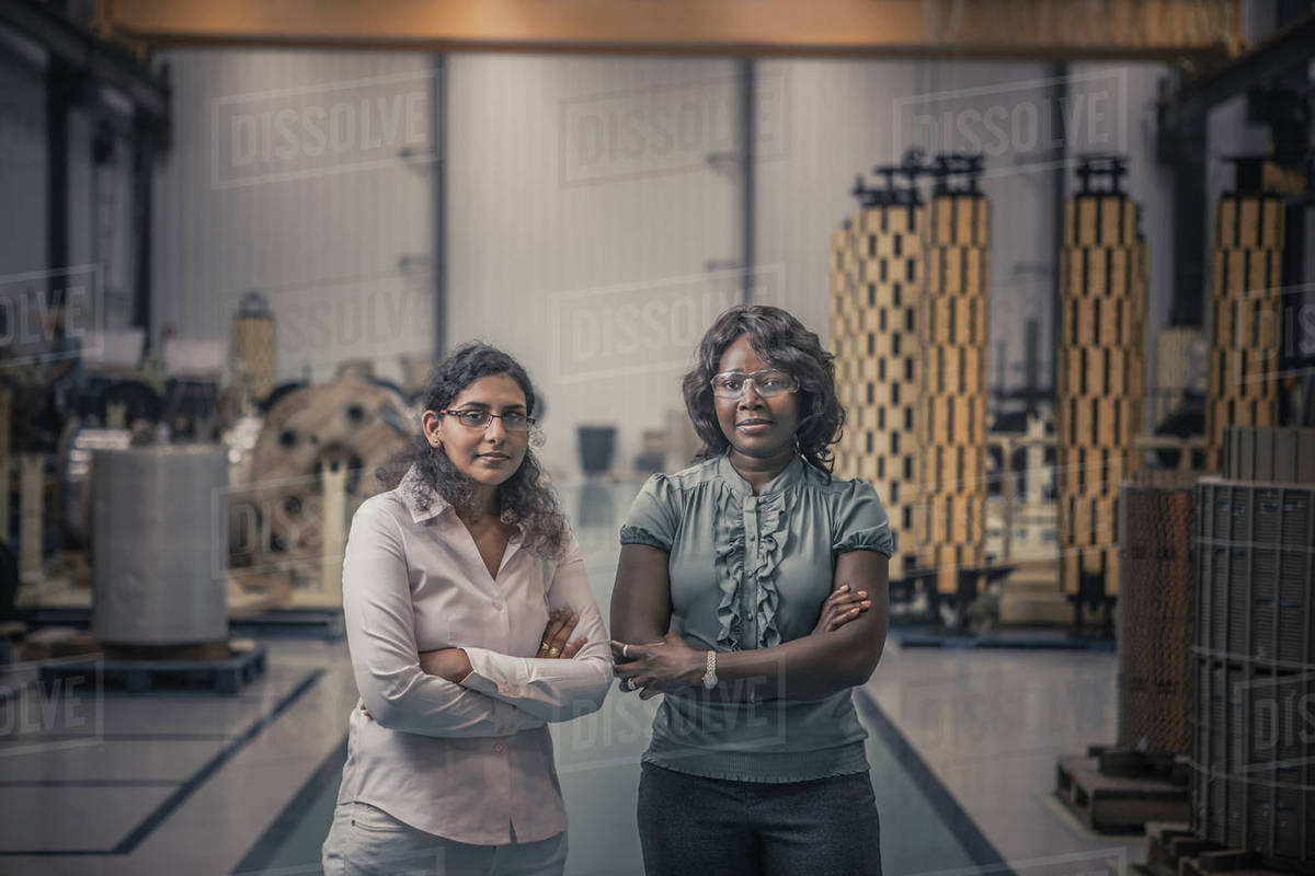 Workers standing together in factory - Royalty-free Stock Photo | Dissolve