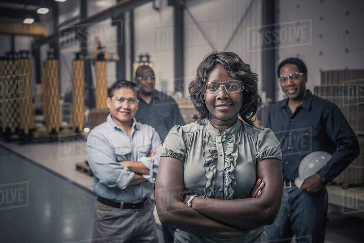 Workers standing together in factory - Stock Photo - Dissolve