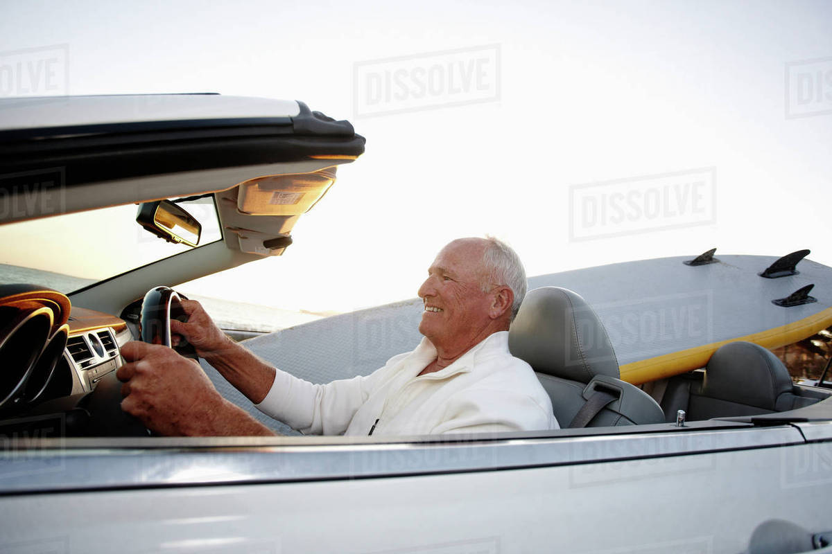 Caucasian man driving convertible - Royalty-free Stock Photo | Dissolve