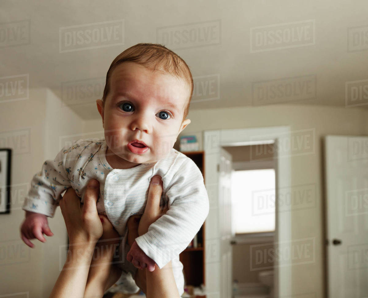 Caucasian mother lifting baby boy - Royalty-free Stock Photo | Dissolve