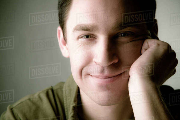 Smiling Caucasian man with head in hands - Royalty-free Stock Photo ...