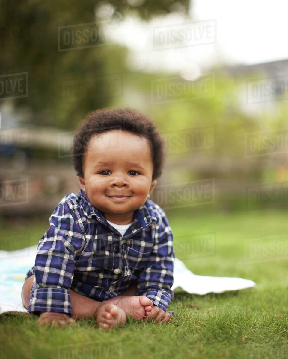 African American baby sitting in grass - Stock Photo - Dissolve