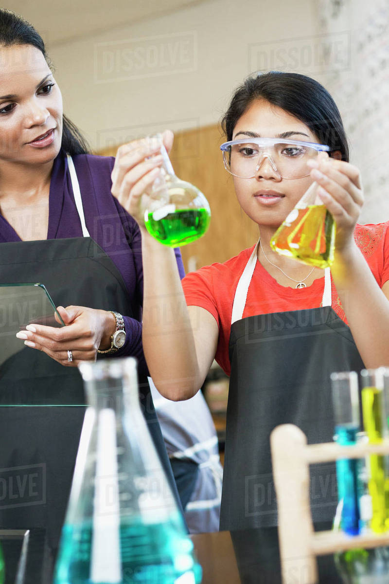 Teacher and student working with chemicals in classroom - Royalty-free ...