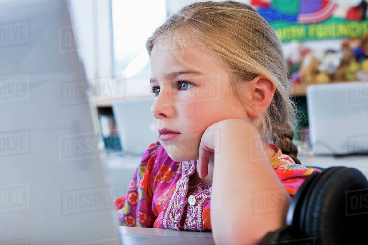 Caucasian girl using computer - Stock Photo - Dissolve