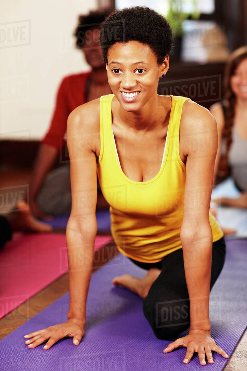 Black woman practicing yoga in class - Royalty-free Stock Photo | Dissolve