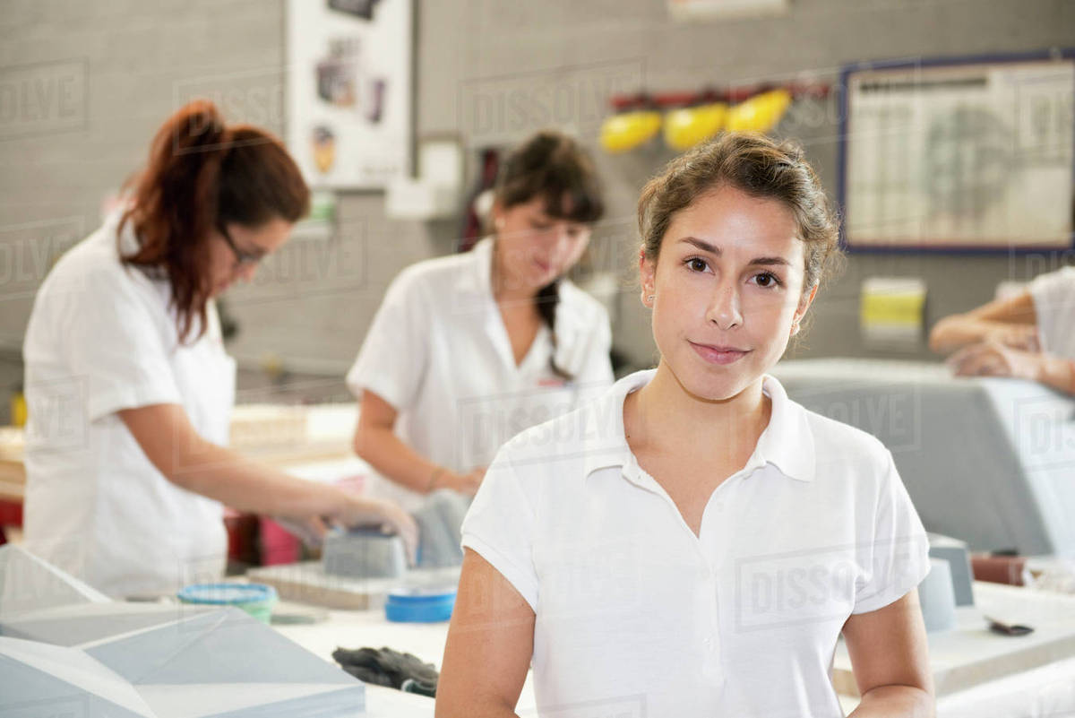 Worker smiling in manufacturing plant - Stock Photo - Dissolve