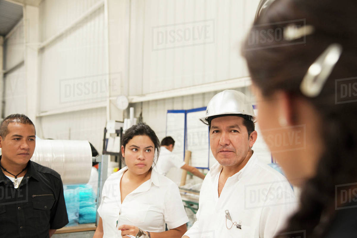 Workers talking in manufacturing plant - Royalty-free Stock Photo ...
