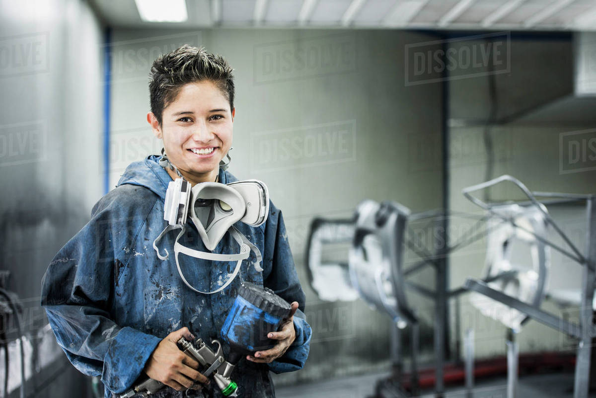 Worker smiling in manufacturing plant - Stock Photo - Dissolve