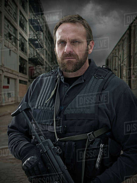 Caucasian policeman on city street - Stock Photo - Dissolve