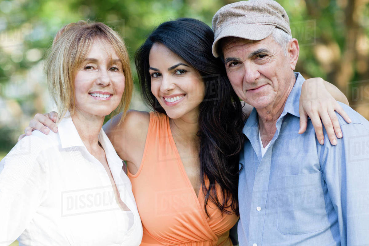 Hispanic family smiling outdoors - Royalty-free Stock Photo | Dissolve