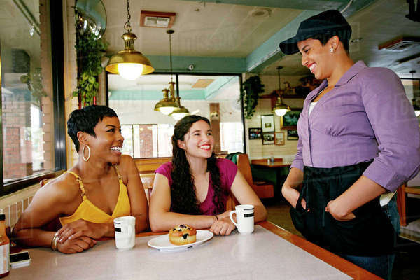 Waitress talking to customers in restaurant - Royalty-free Stock Photo ...