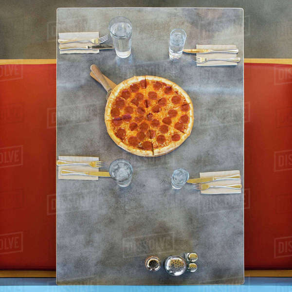 Pizza on table in restaurant - Royalty-free Stock Photo | Dissolve