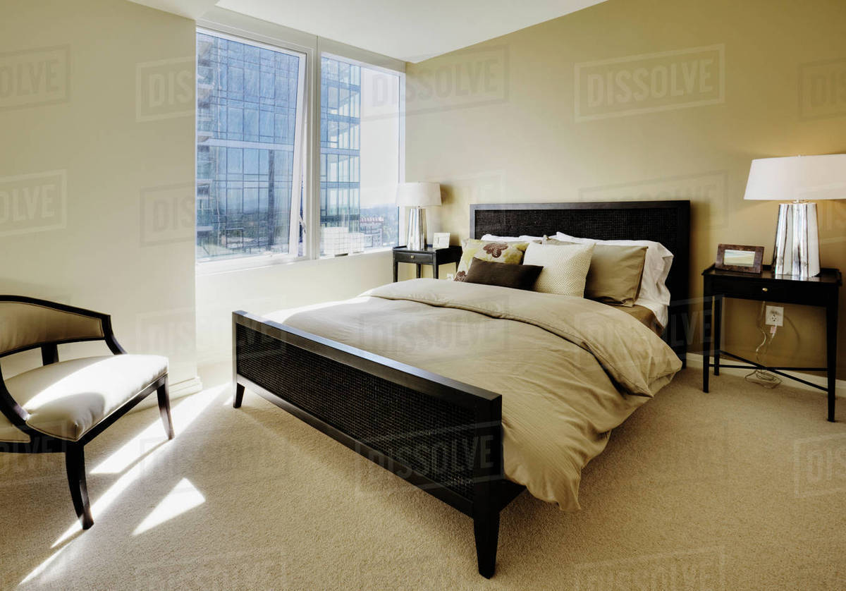 Bedroom in luxury highrise apartment - Stock Photo - Dissolve