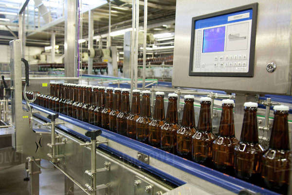 Bottles on production line in bottling plant - Stock Photo - Dissolve