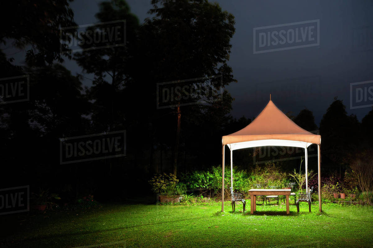 Illuminated canopy and table in garden - Royalty-free Stock Photo ...