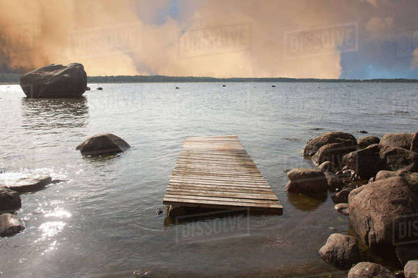 Pier Floating on a Rocky Shore - Stock Photo - Dissolve