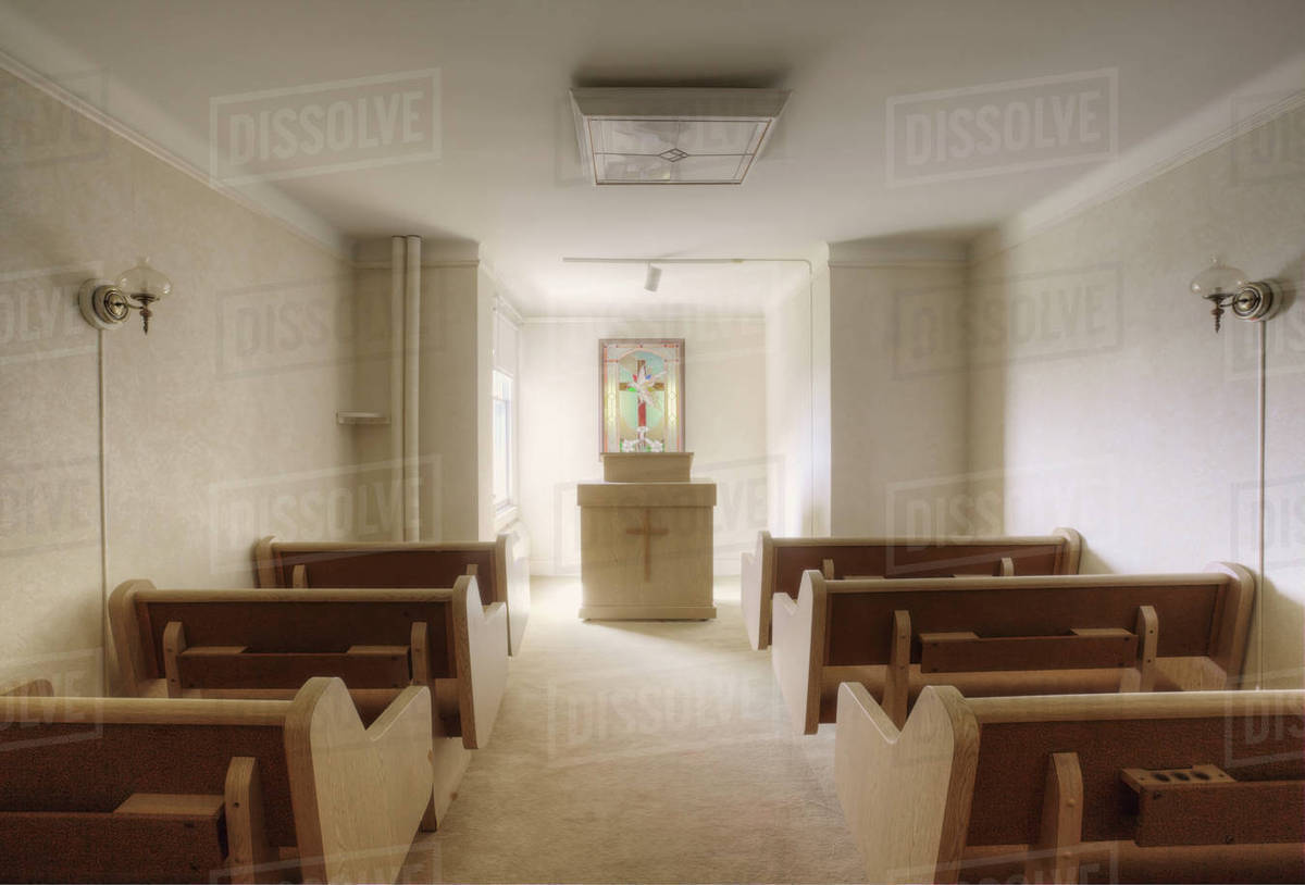Small religious room, a former chapel with pews - Stock Photo - Dissolve