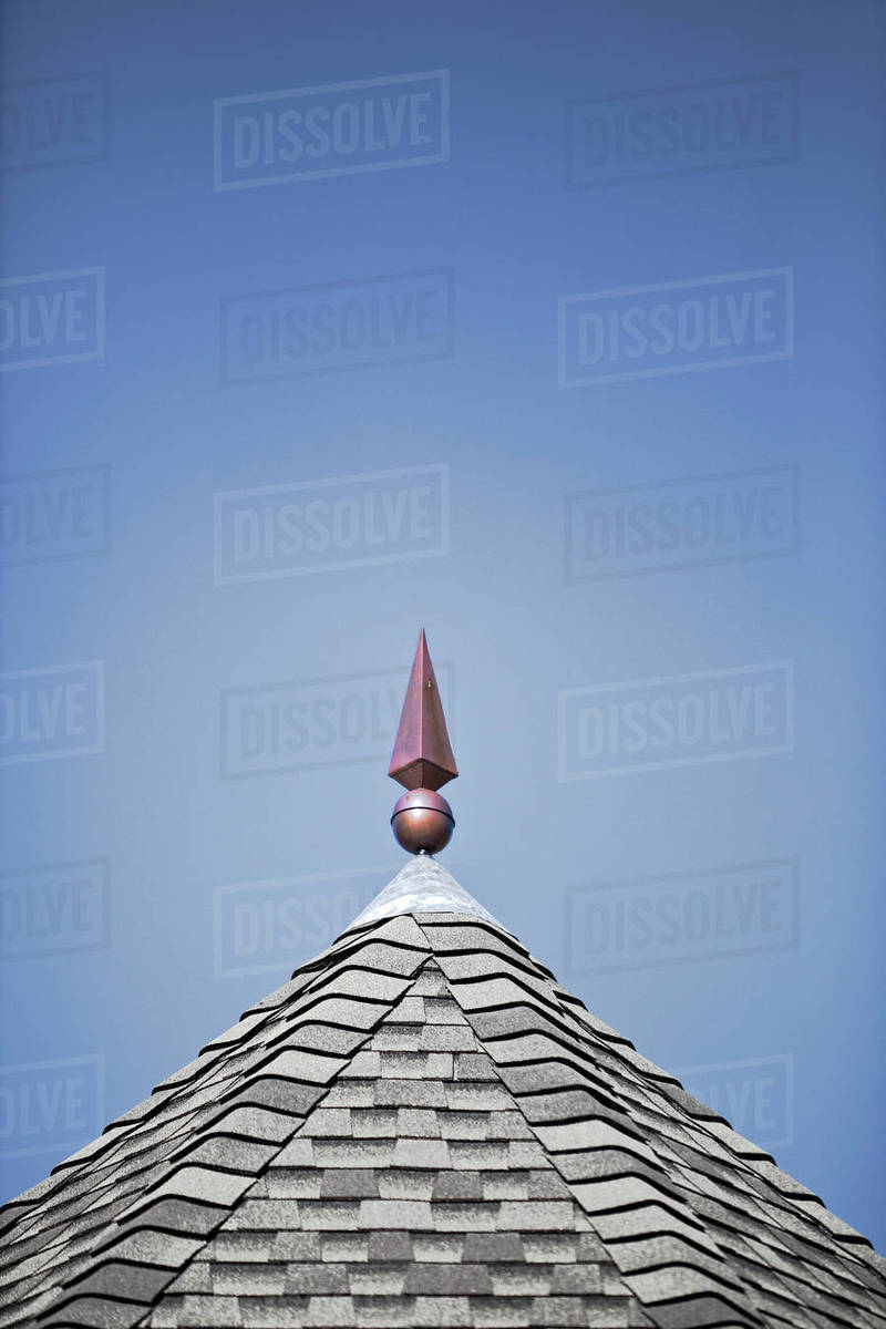 A shingle roof, with small grey times, and a central pinnacle - Stock ...