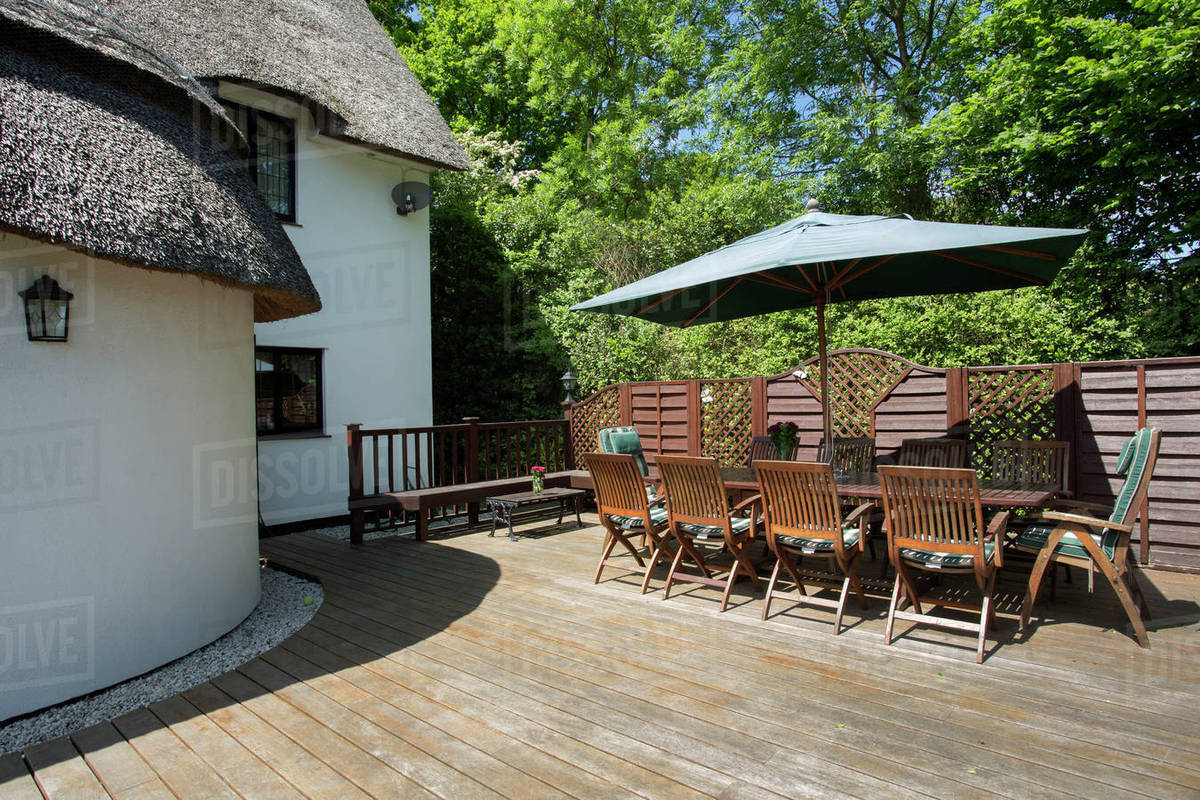 Table and chairs on cottage patio - Royalty-free Stock Photo | Dissolve