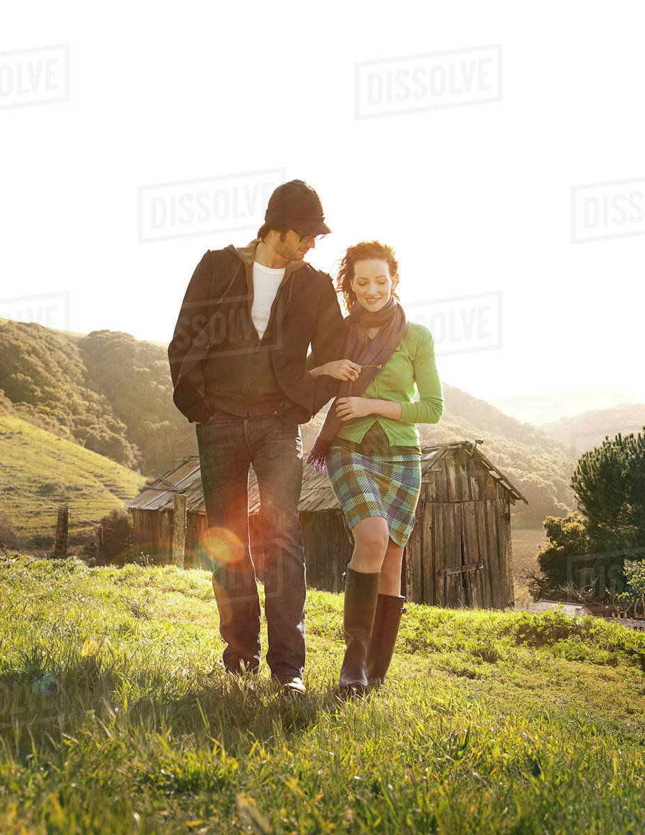 Couple walking in rural landscape - Royalty-free Stock Photo | Dissolve